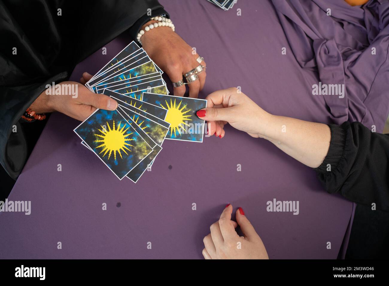 Tarot cards, fortune teller hands on a table background, top view ...
