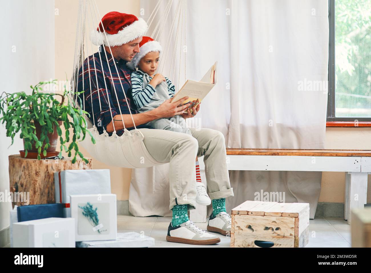 Christmas, what a special chapter. a young man reading a book with his ...