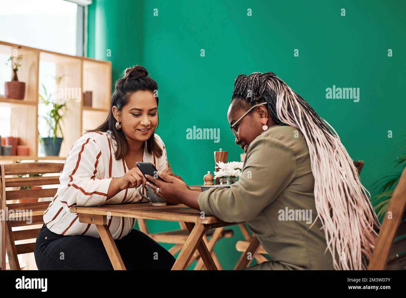 Bestie catch up time is the best time. two young women using a ...