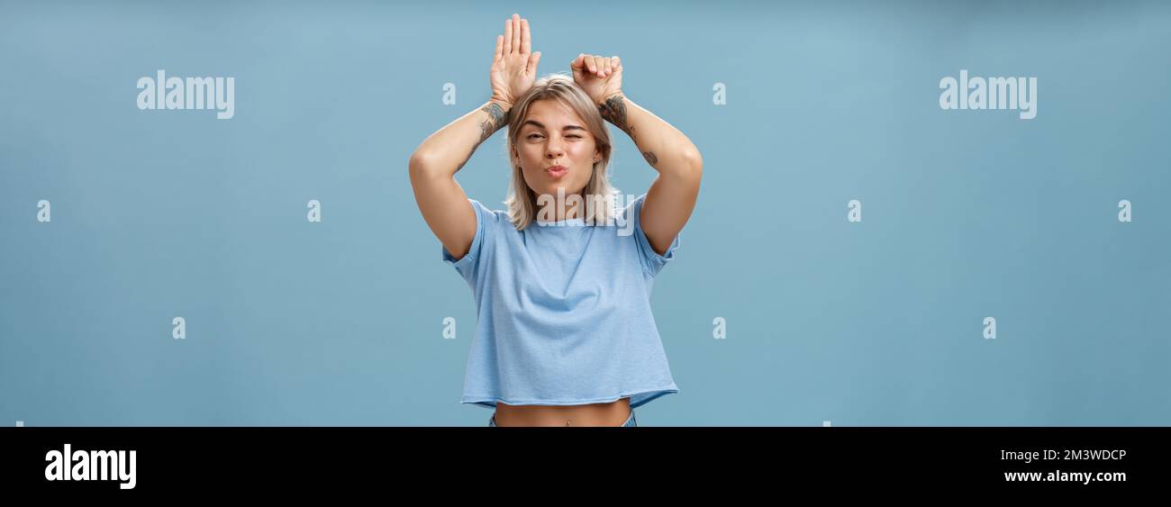 Flirty attractive and stylish cool girlfriend with tattooed arms and ...