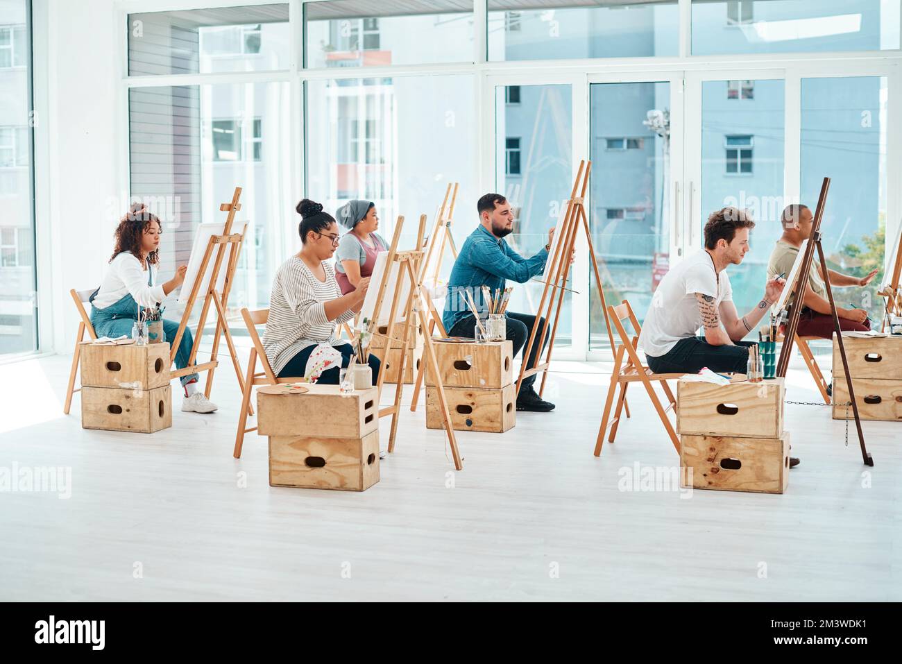 Art class in session. Full length shot of a diverse group of artists ...