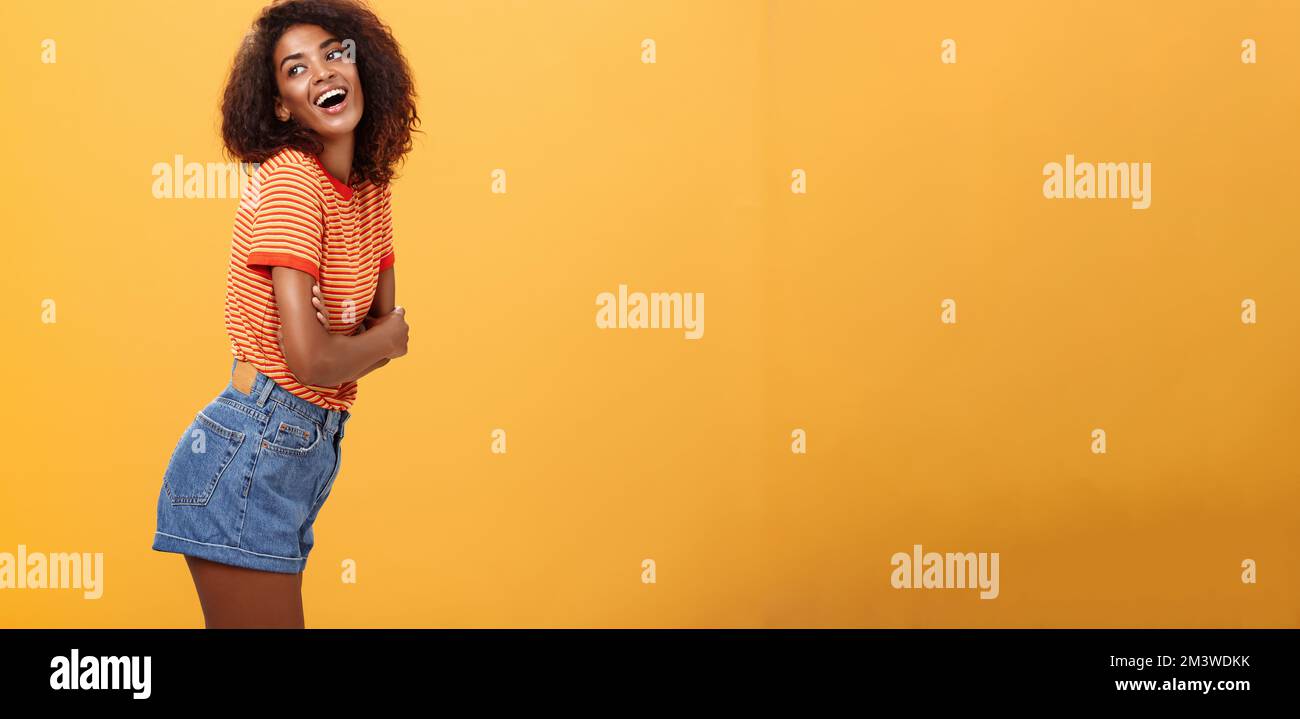 Hey wanna hang out. Sensual and flirty carefree stylish dark-skinned woman with curly hair ...