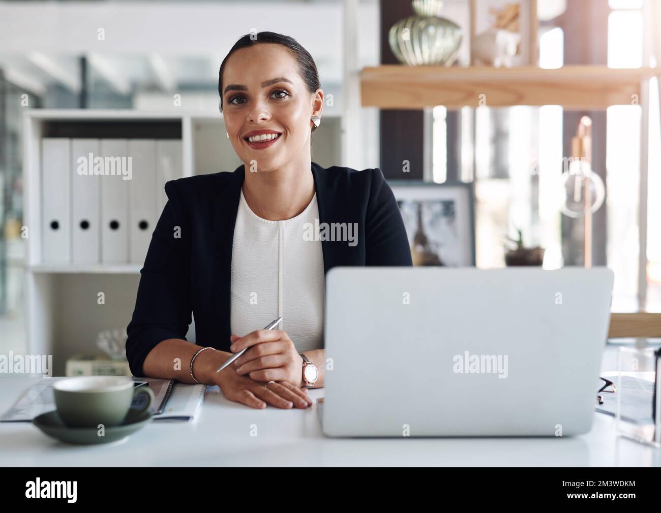 She always works with a smile on her face. Portrait of an attractive ...