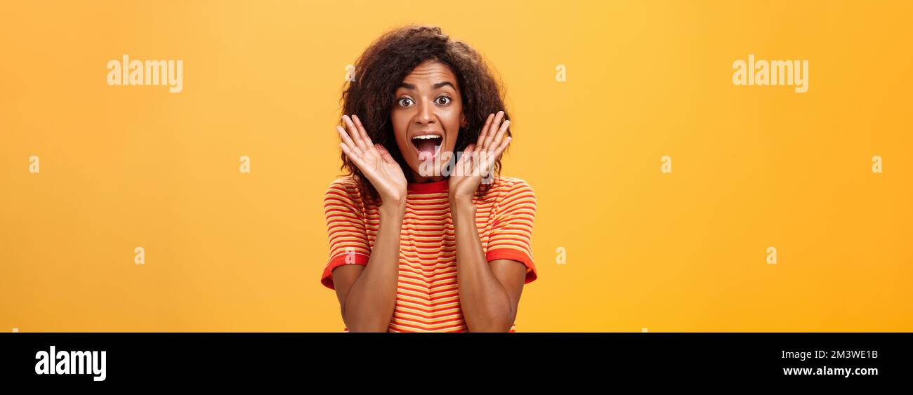 Waist-up shot of impressed excited talkative dark-skinned woman with ...