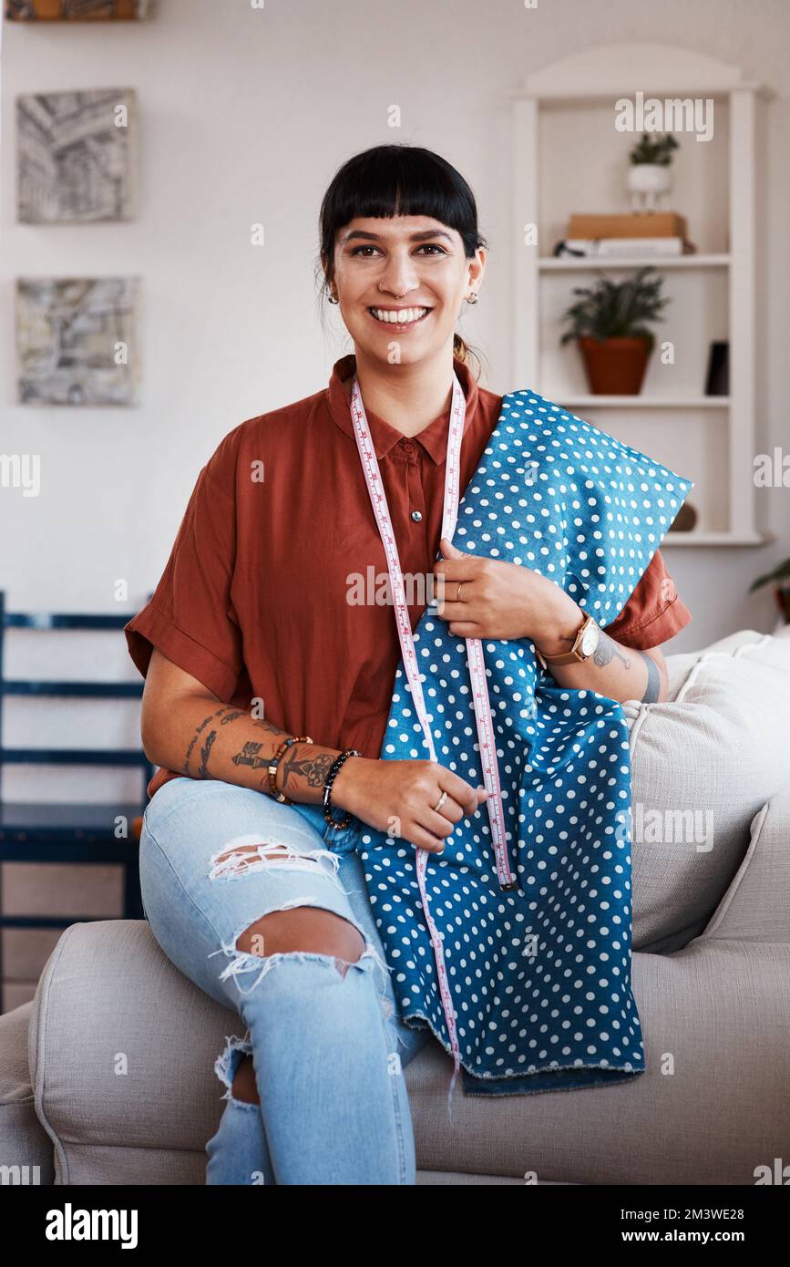 Making clothes is something I love. a clothes maker posing with fabric ...