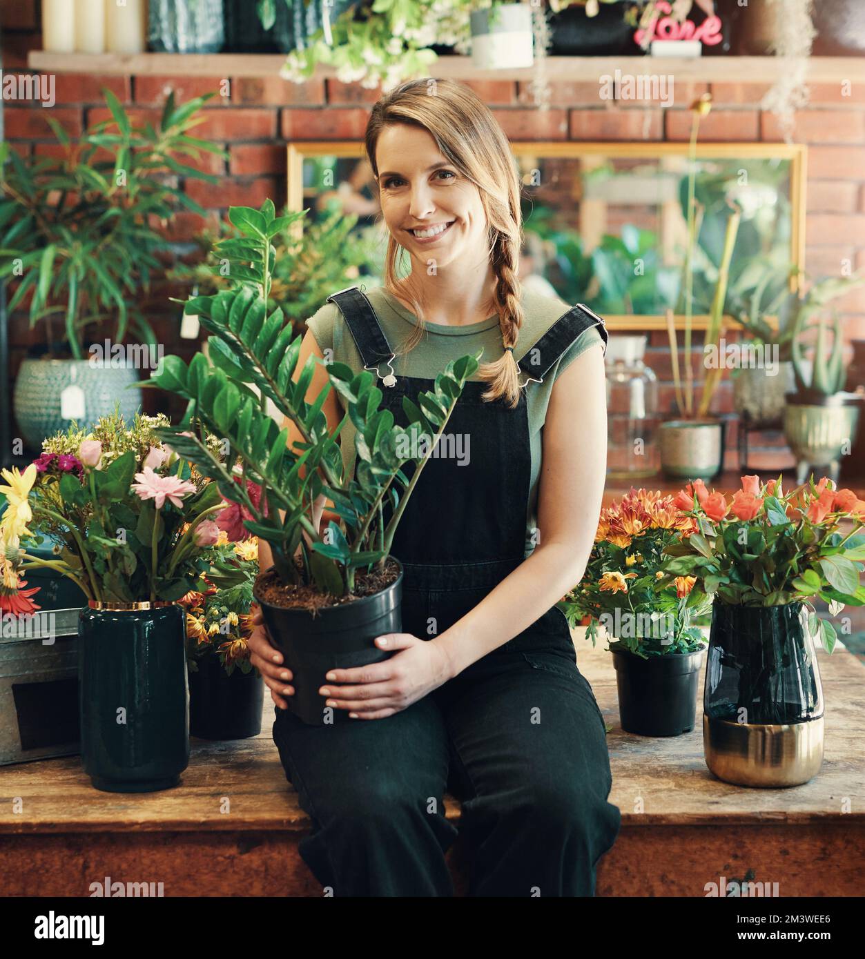 Take your pick of plants. Cropped portrait of an attractive young ...