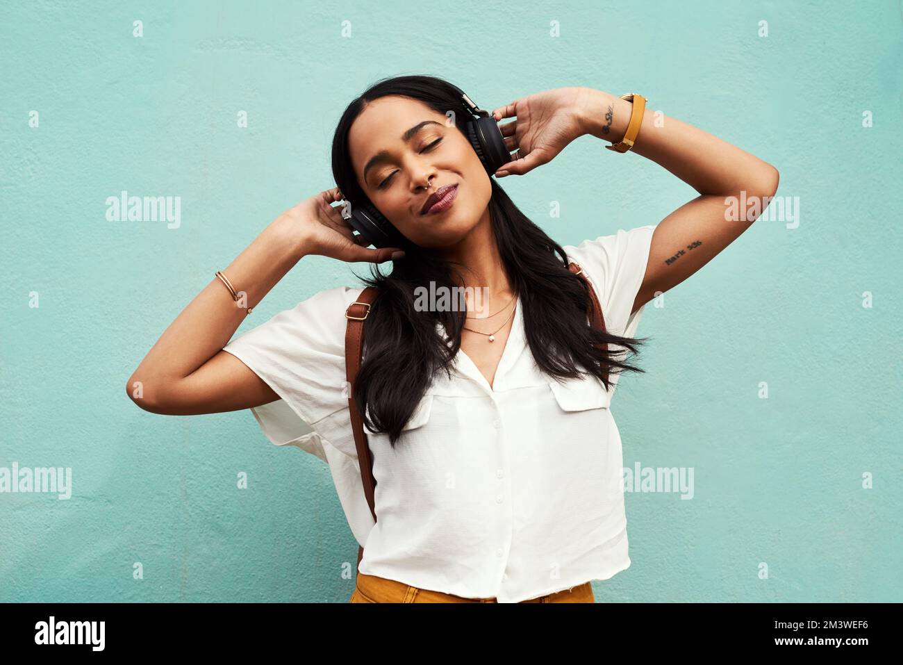 Music is for the soul. an attractive young woman standing alone and ...