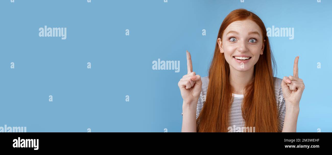 Thrilled happy young rejoicing redhead girl get awesome chance look ...