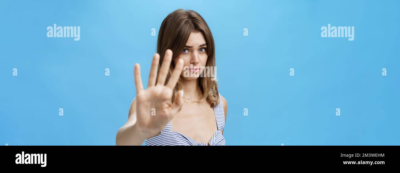 Silly and shy insecure attractive girl pulling hand towards to cover ...