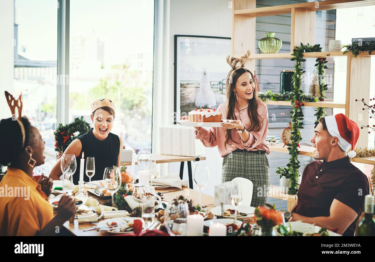 Our cakes ready. an attractive young woman holding a cake during ...