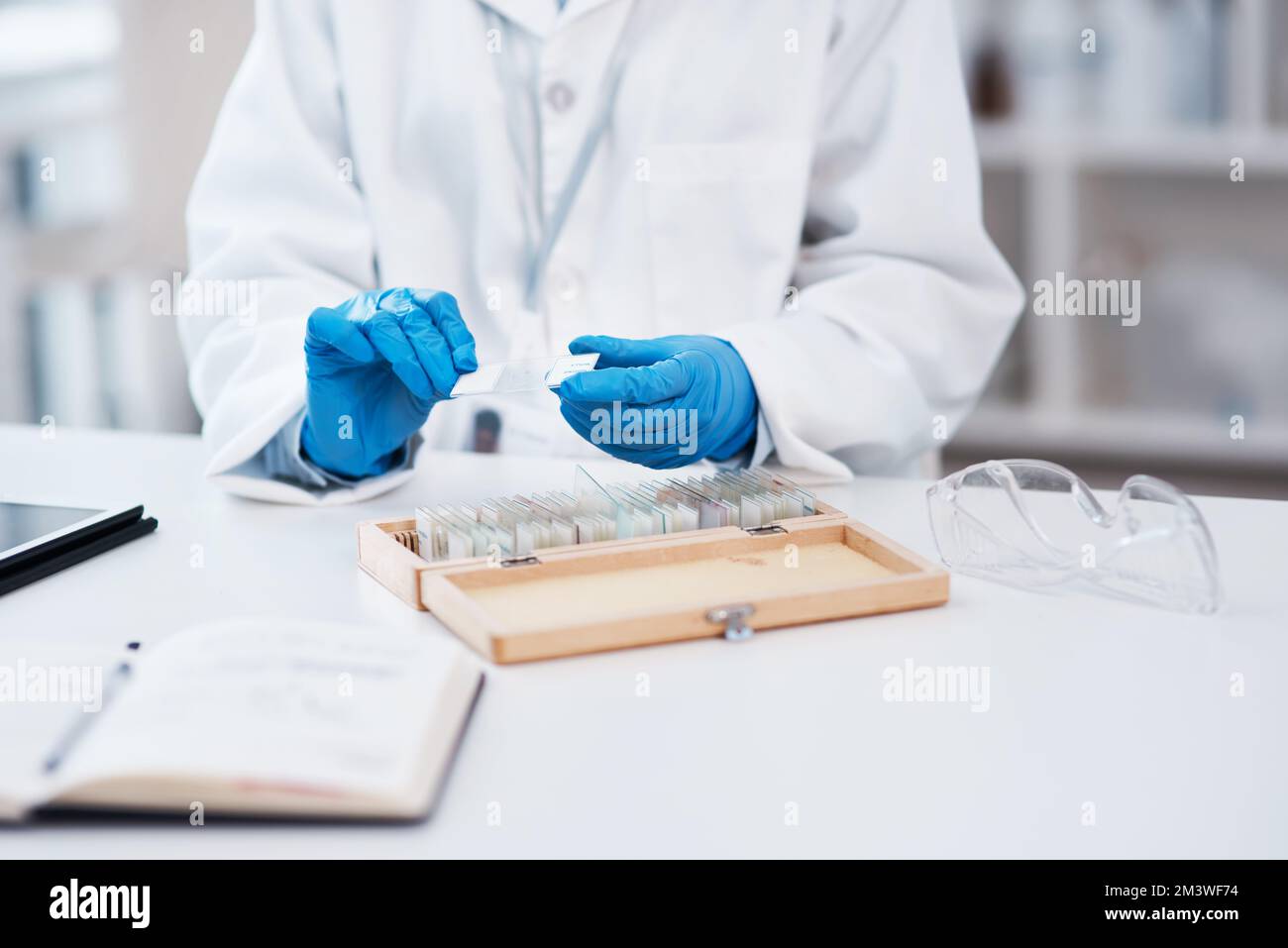 Every slide has a story to tell. Closeup shot of an unrecognisable ...