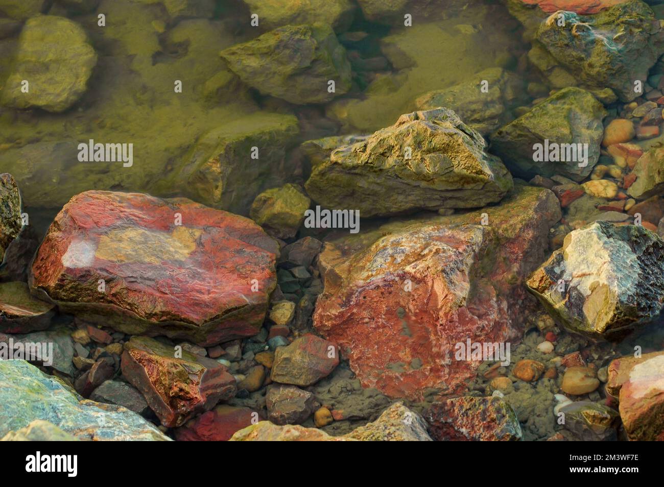 The colorful rocks in the river water Stock Photo - Alamy