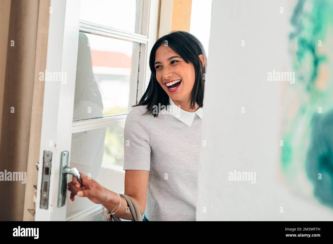 Attractive woman opening door hi-res stock photography and images - Alamy
