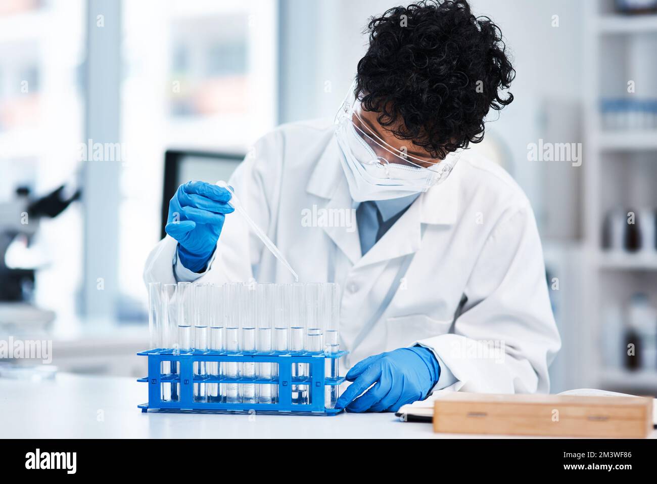 One drop can result in big reactions. a young scientist using a dropper ...