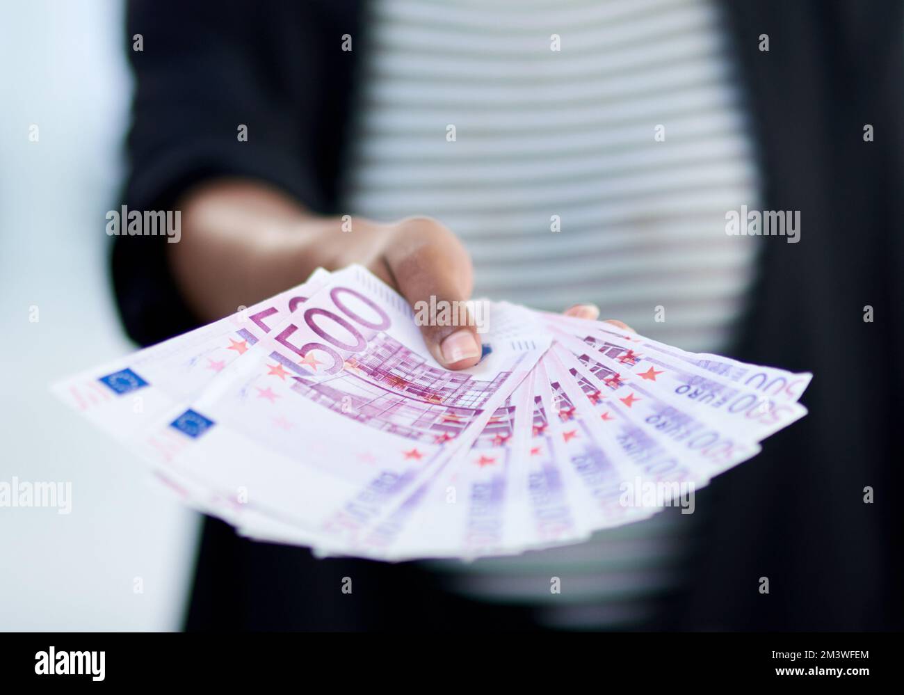 Cash talks. an unrecognizable businesswoman holding a stack of money ...