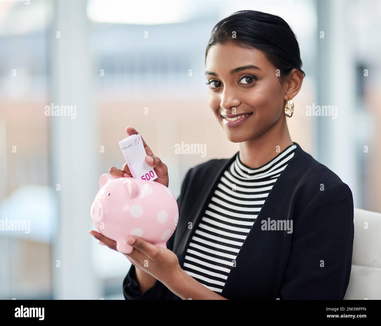 Make saving money a habit. Portrait of an attractive young ...