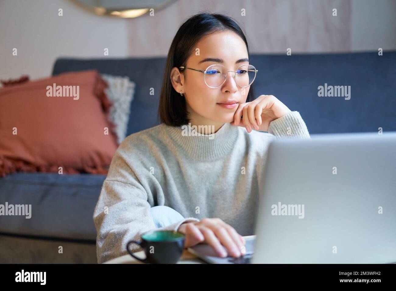 Portrait of smiling asian girl working from home, staying on remote ...