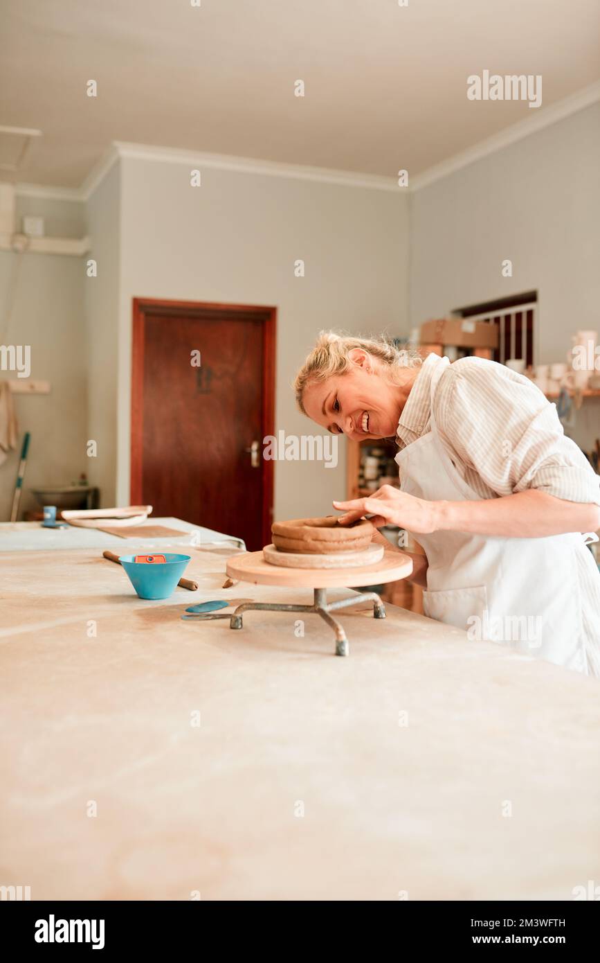 Creative work increases positive emotions. a female artisan working in ...