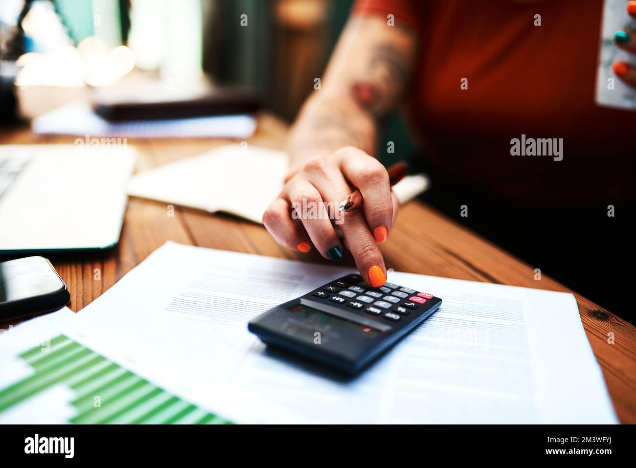 Double checking my calculations. an unrecognizable businesswoman ...