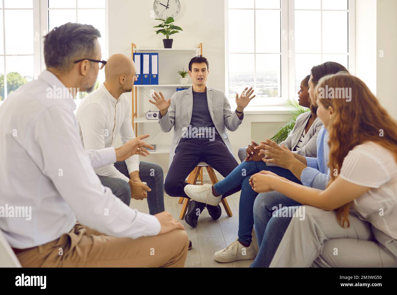 Business team sitting in the office, having a work meeting and ...