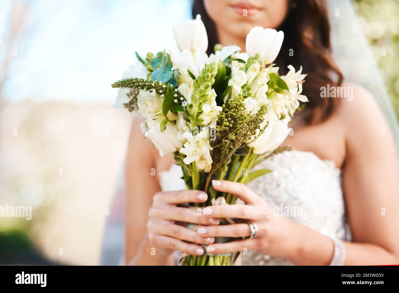 Holding the flowers of happiness. an unrecognizable bride holding a ...