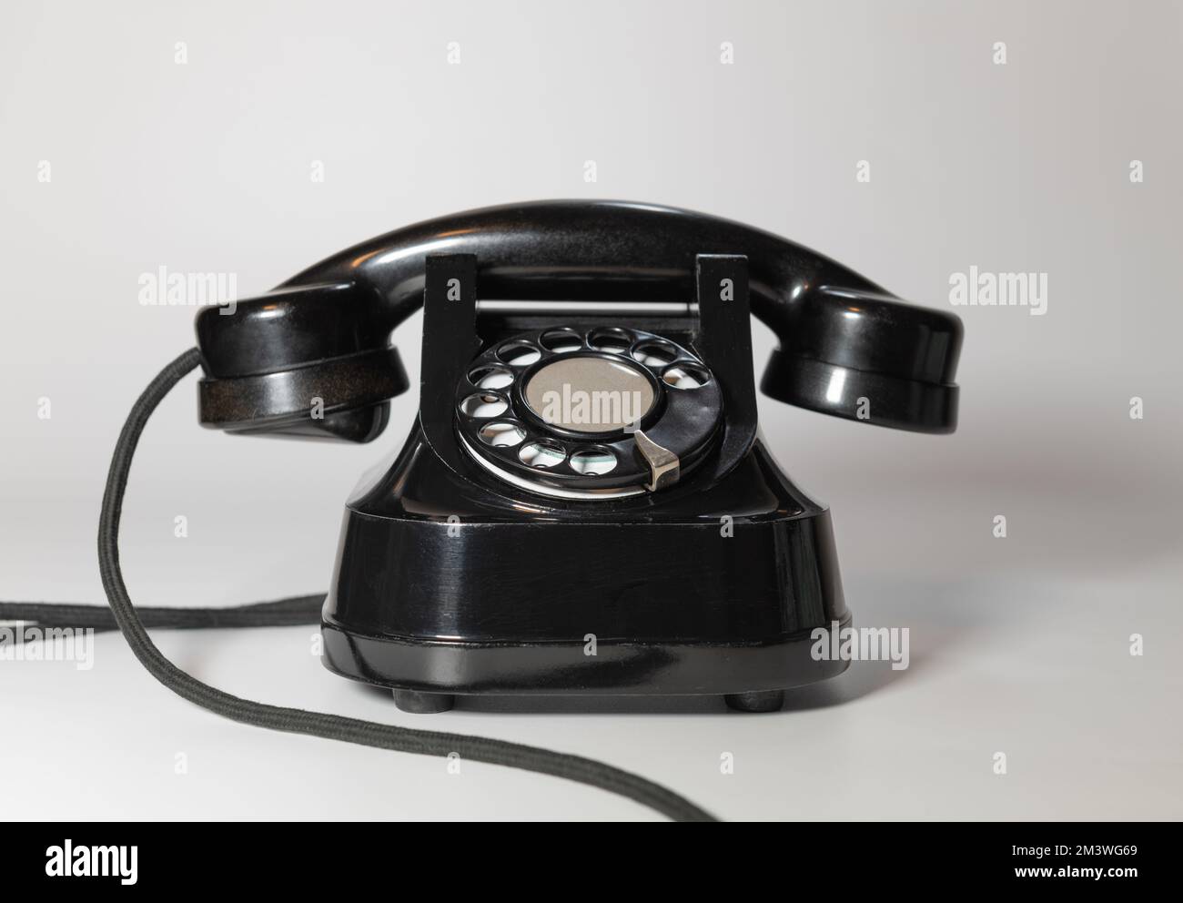 old rotary black telephone 50s - 60s with traces of time. on white ...