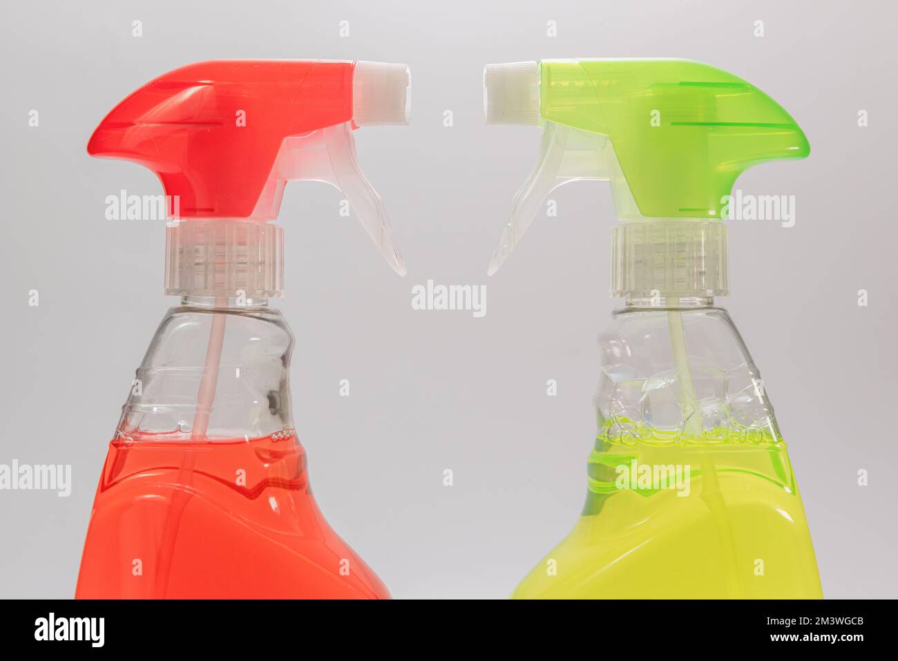 Two containers with detergent - red, green. close up. on a white-blue ...