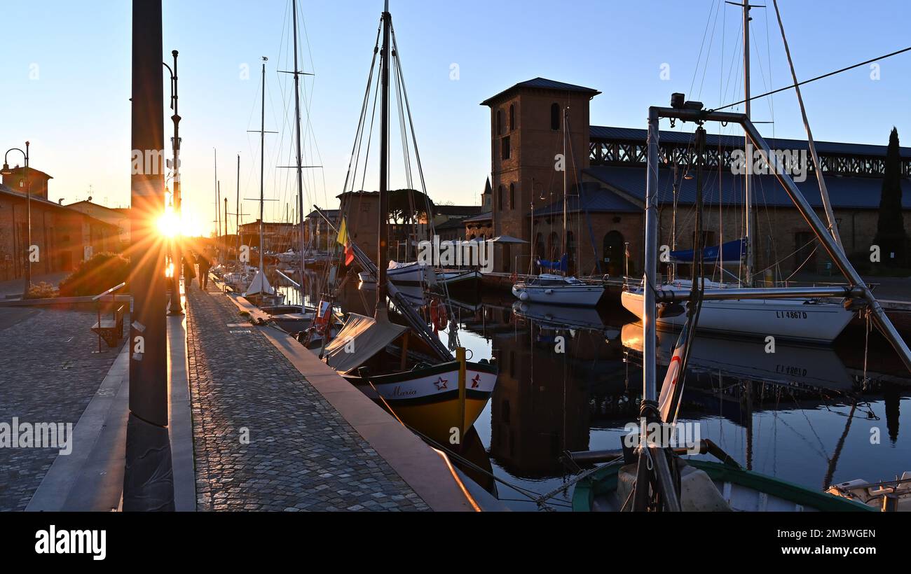 The canal port and the dock of Cervia at sunset. On the right, the old ...