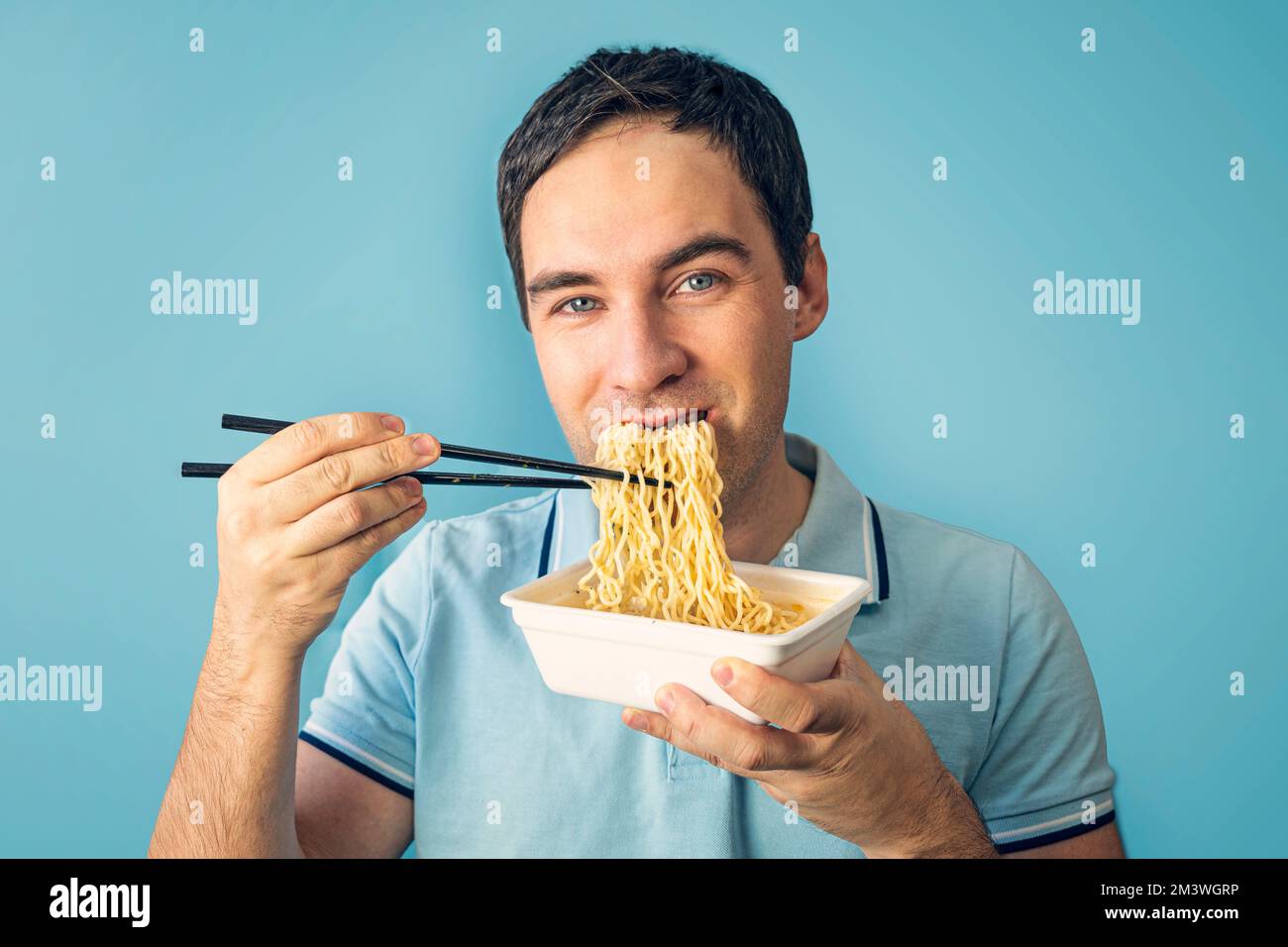Young male eating ramen noodles hi-res stock photography and images - Alamy