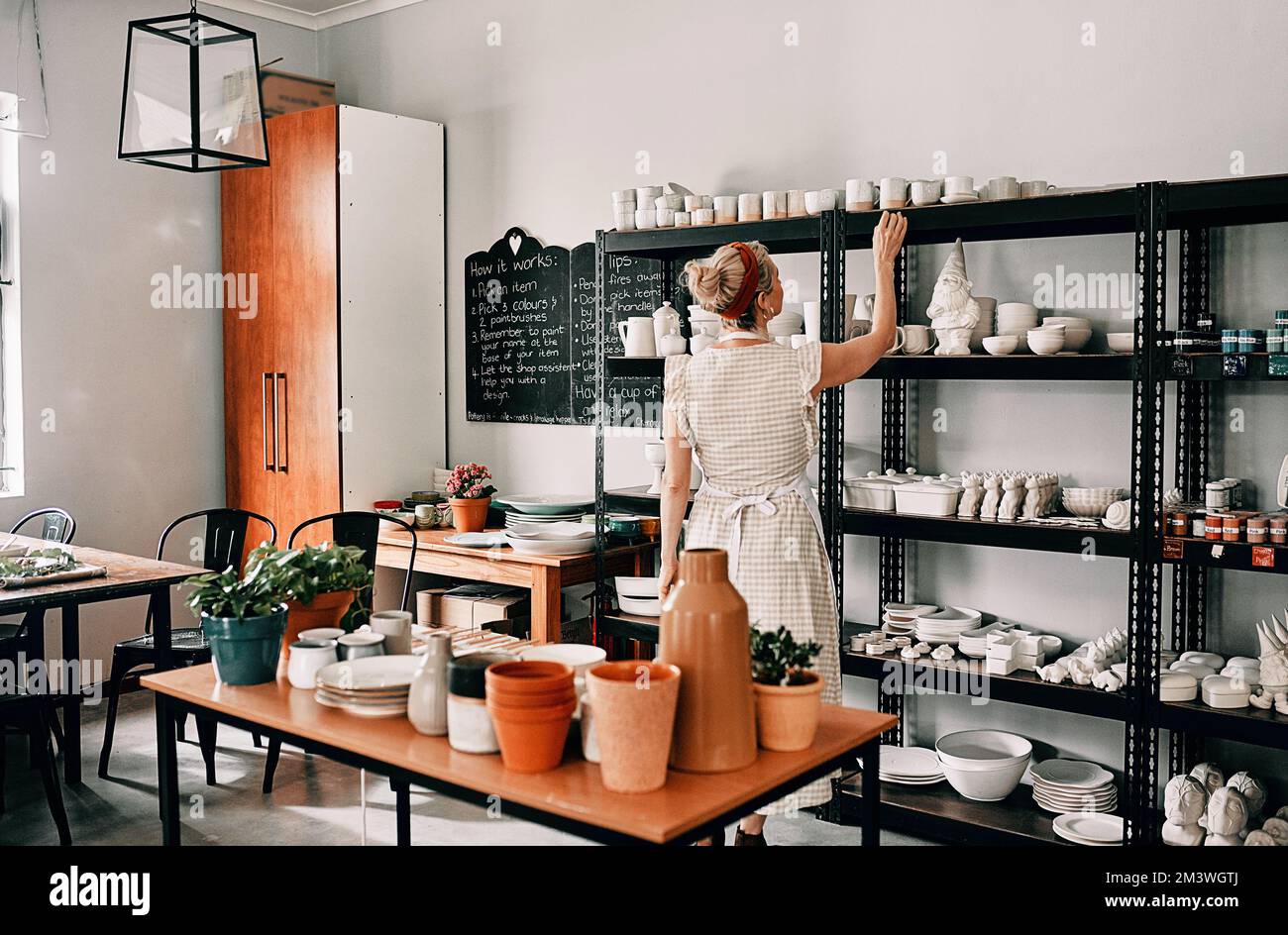 Making sure everything is neat and tidy. an unrecognizable woman ...