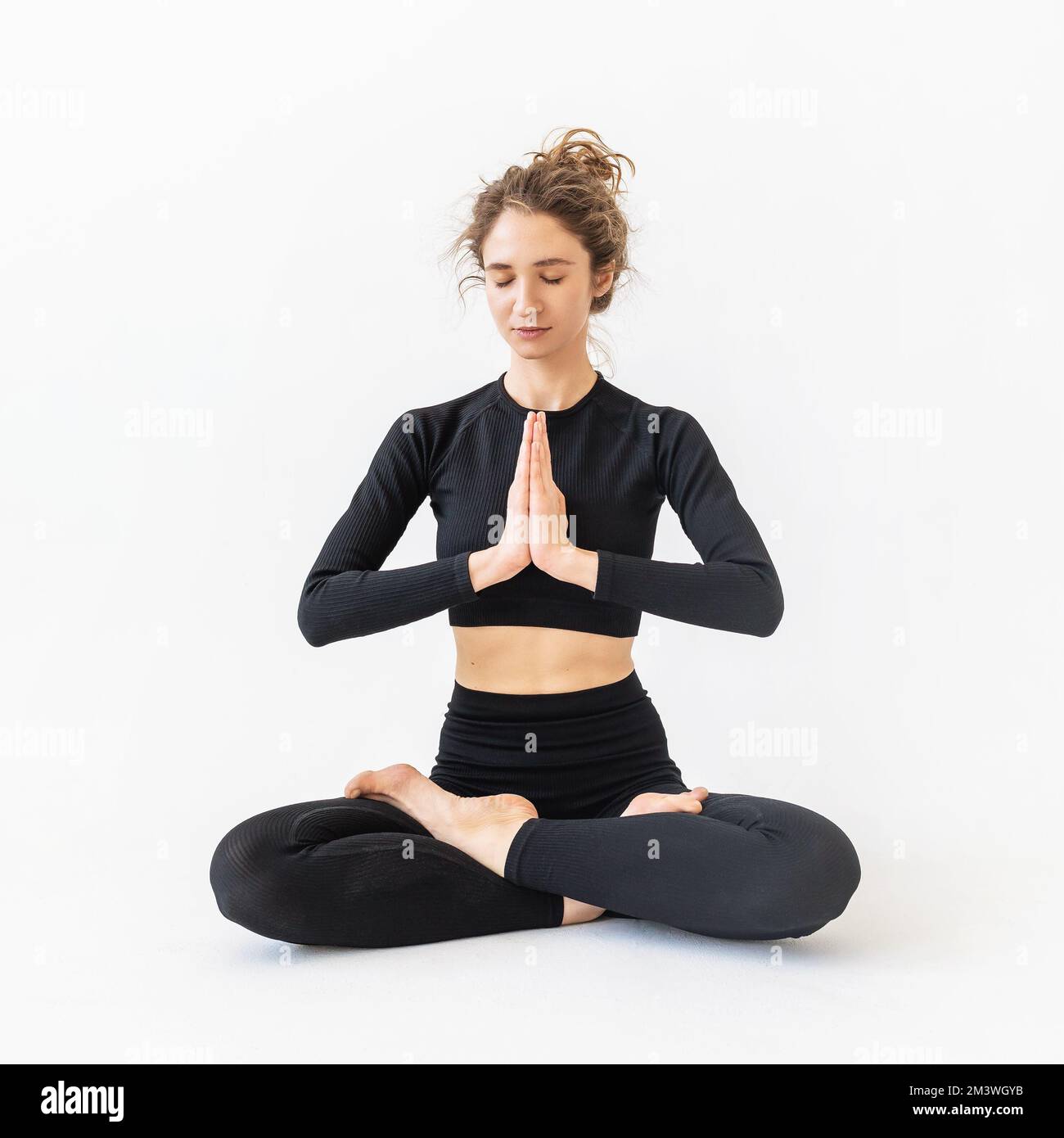 Young woman leading a healthy lifestyle and practicing yoga, doing ...