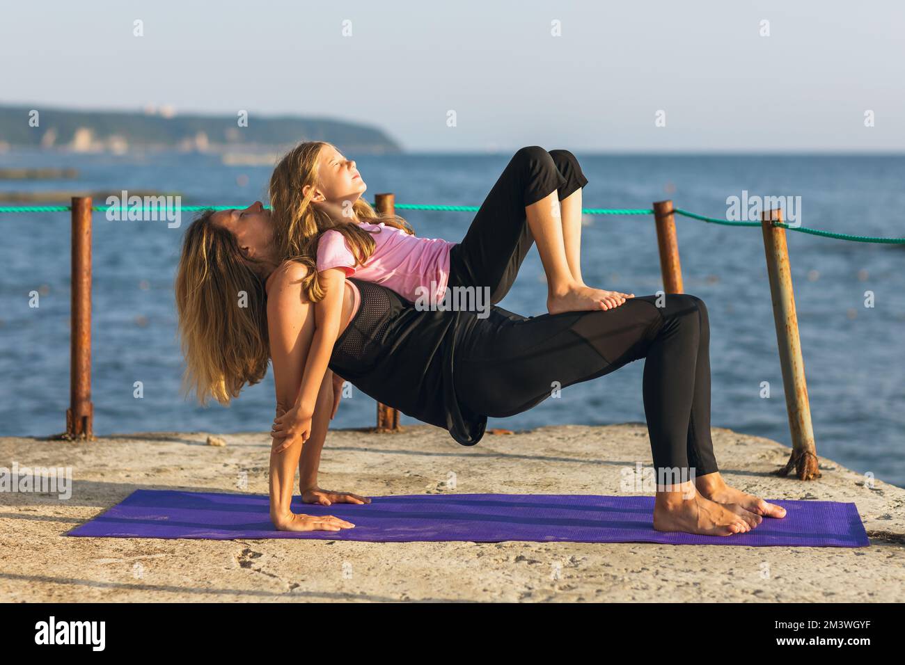 Mom and daughter lead a healthy lifestyle and practice yoga, on the ...