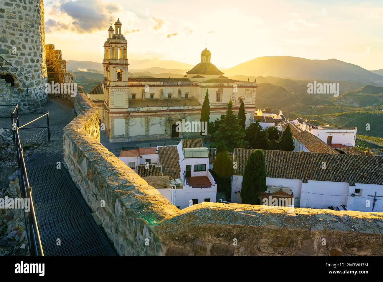 Spectacular sunset over the mountains with the old church and the white ...