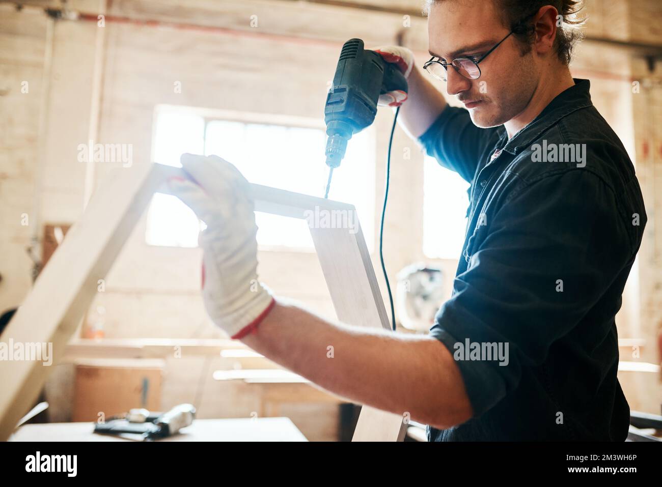 This work of art is almost complete. a handsome young carpenter using ...