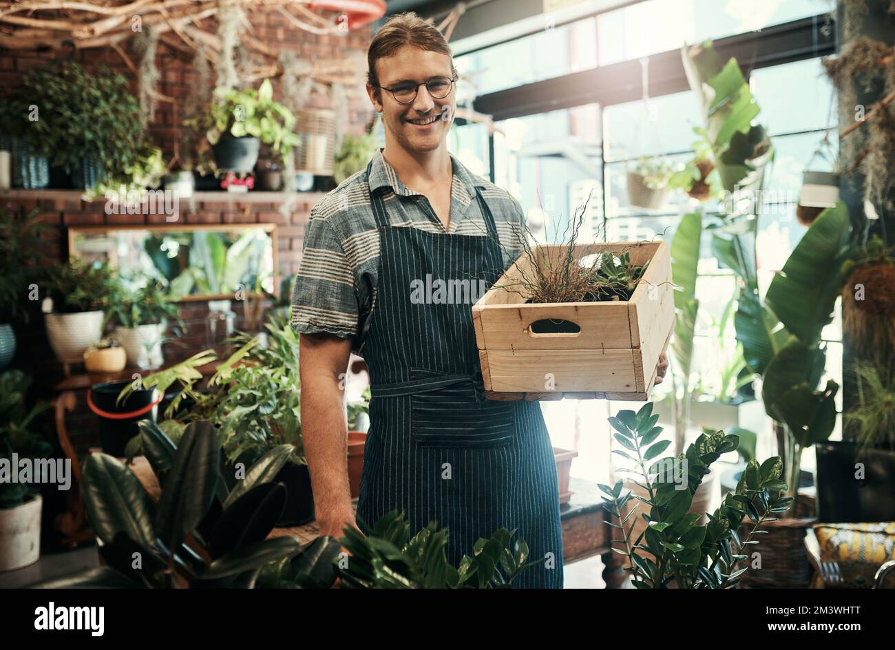 Working with plants makes me happy. Portrait of a handsome young ...