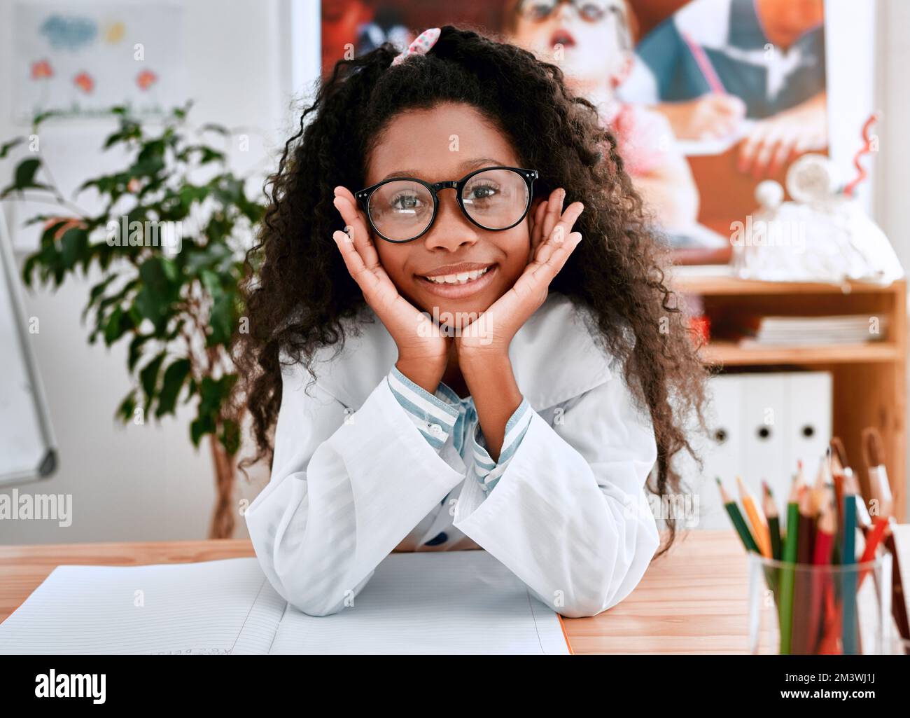 Shes always happy and ready to learn. Portrait of an adorable young ...
