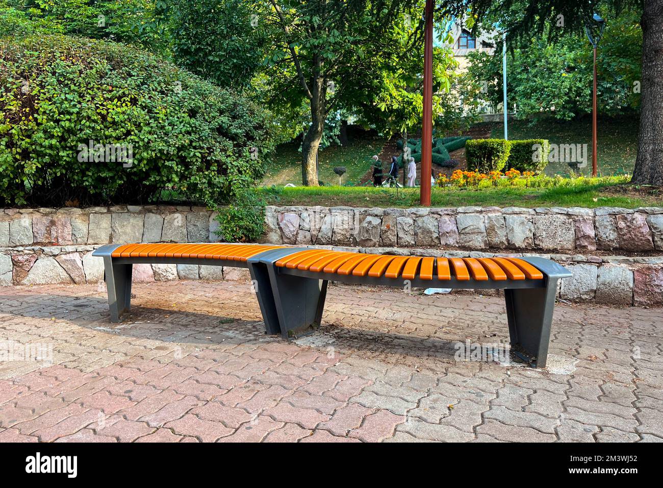 A modern wooden bench in a public park Stock Photo - Alamy
