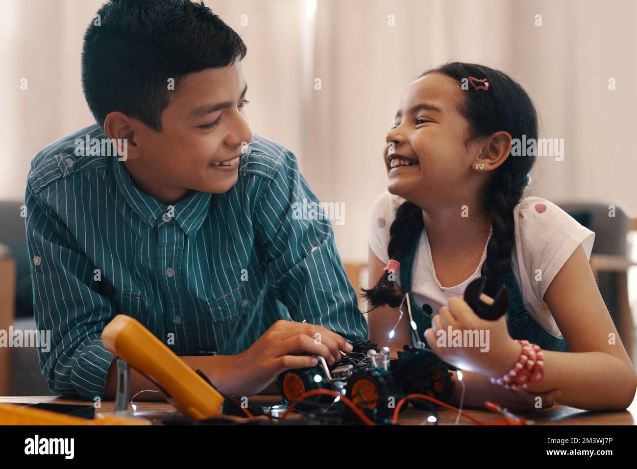 We always have fun when we work together. two adorable young siblings ...