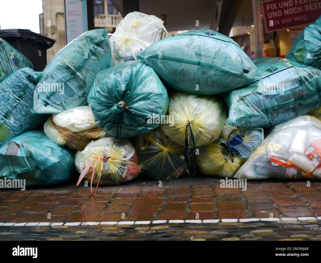 lot of filled bin liner street Stock Photo - Alamy