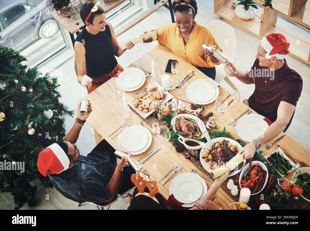Its time to pop the crackers. High angle shot of a group of cheerful ...