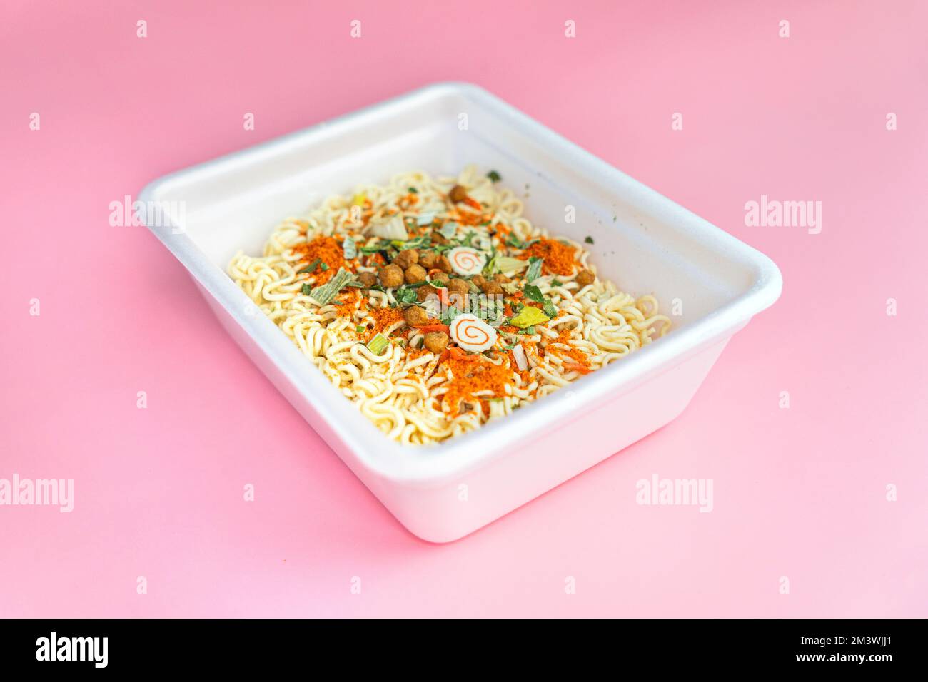 Dried Instant Noodles in Plastic Box on the pink table. top view Stock ...