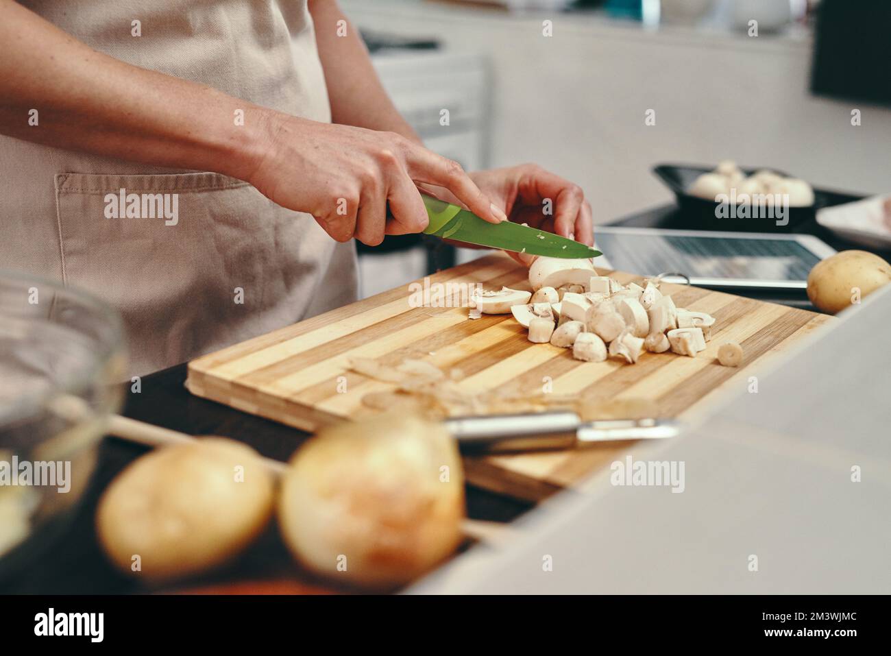 Chopping it up in the kitchen. an unrecognizable woman chopping up ...