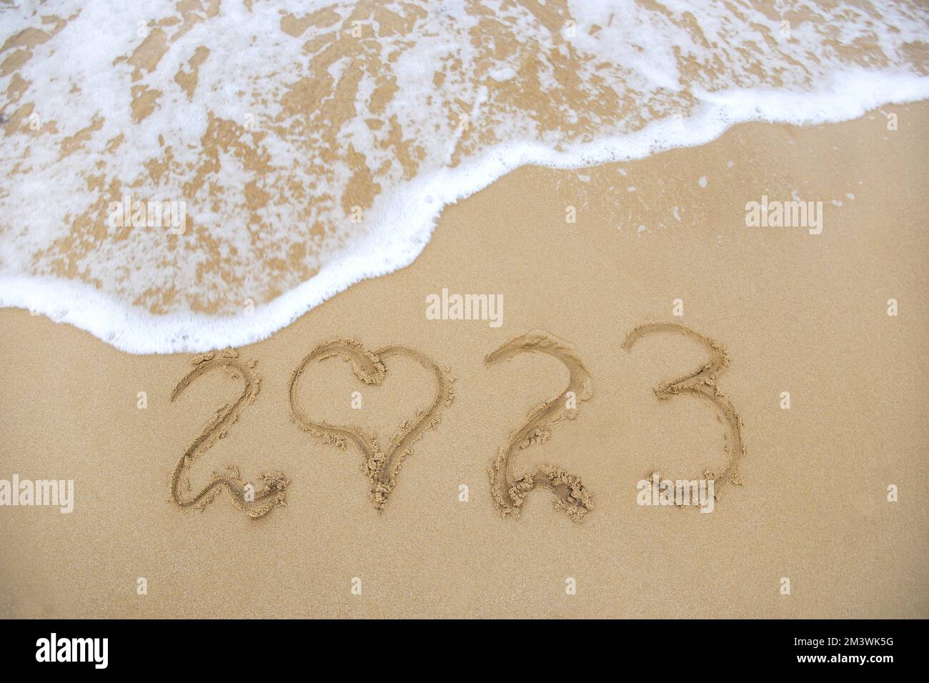 2023 year written on sandy beach sea. Top view. Flat lay Stock Photo ...