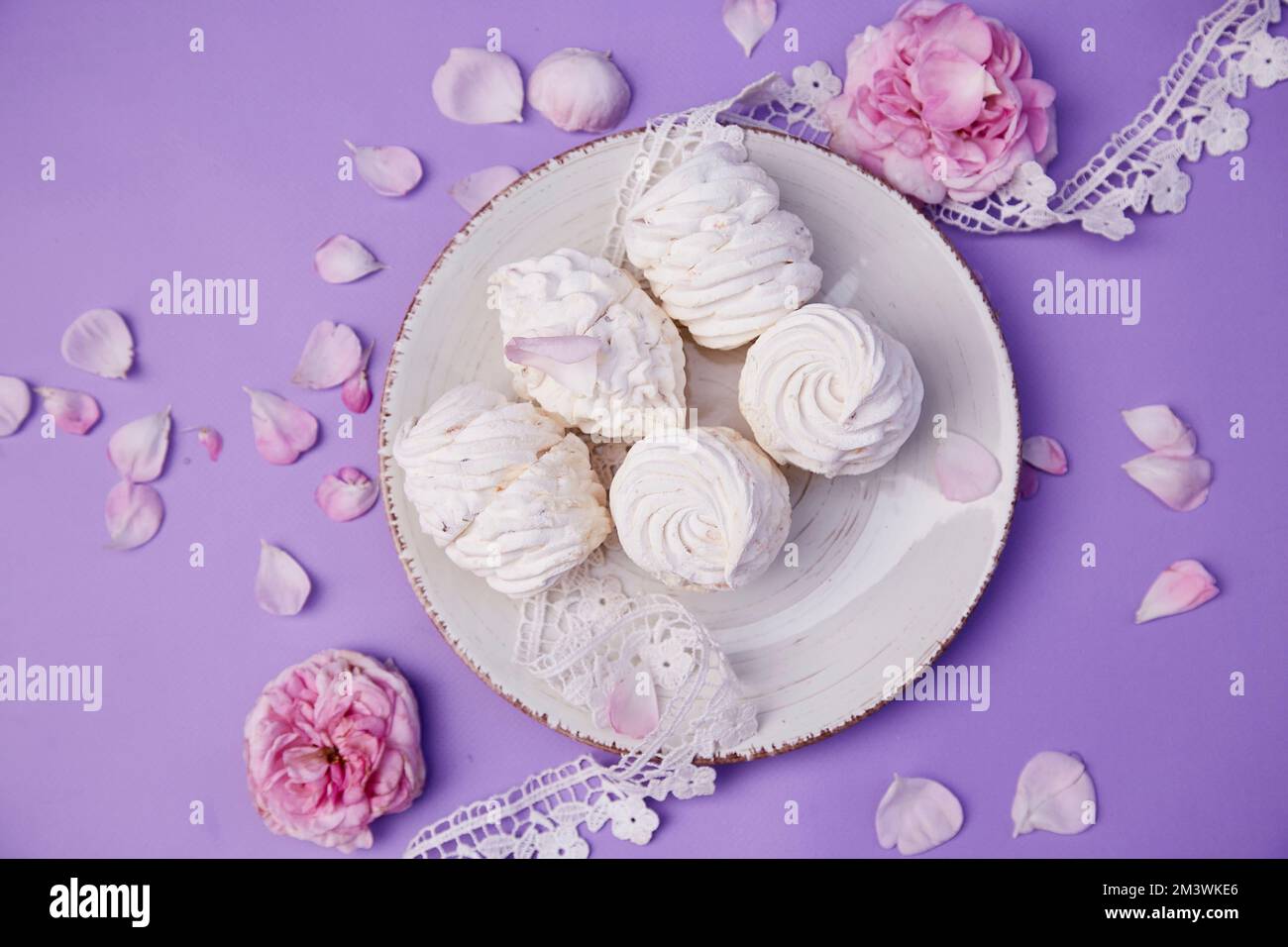 Delicate aesthetic vanilla no sugar marshmallows on purple background ...