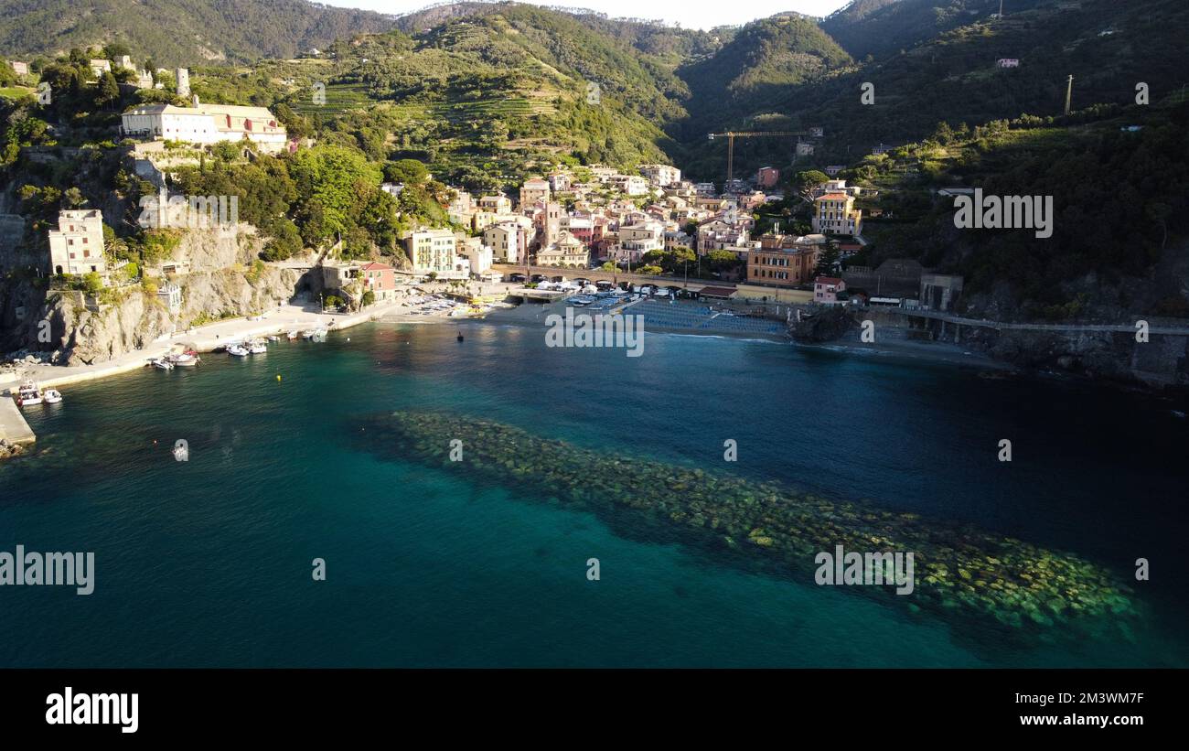 An aerial drone shot of a blue sea in the town of Monterosso al Mare ...
