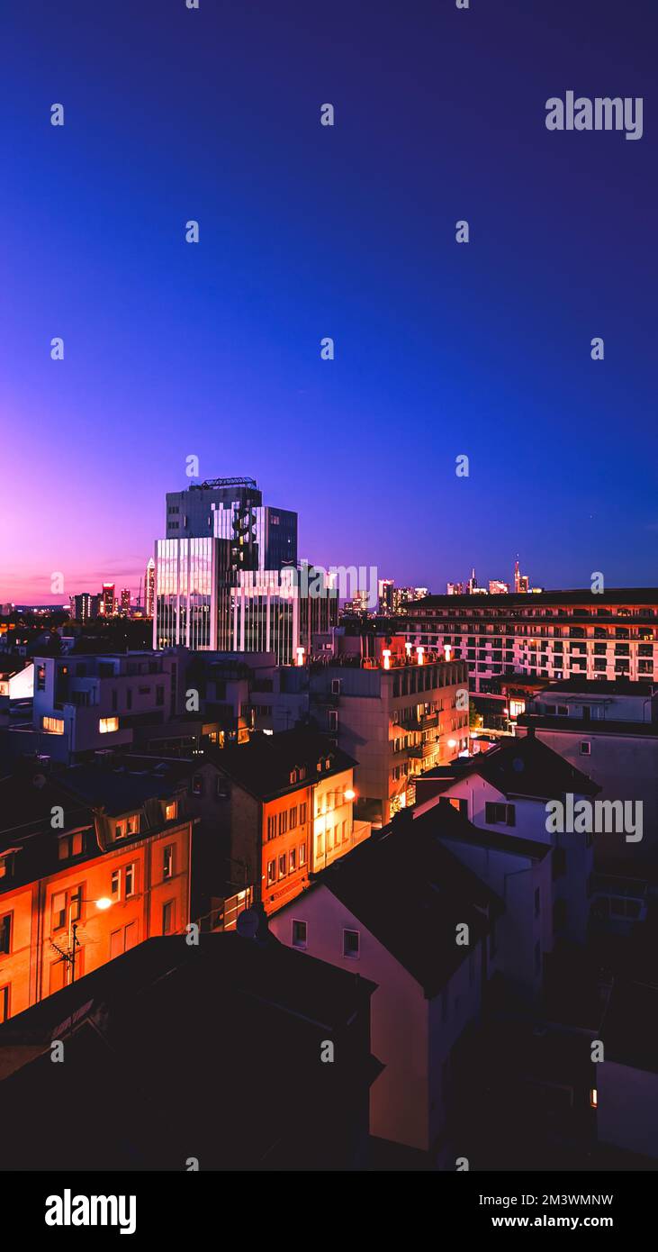A vertical shot of a cityscape at sunset Stock Photo - Alamy