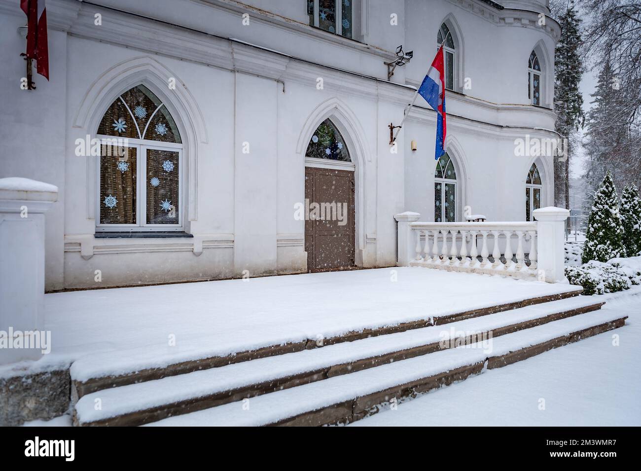 Closed wooden door and gothic arch. Main entrance of Baldone White ...