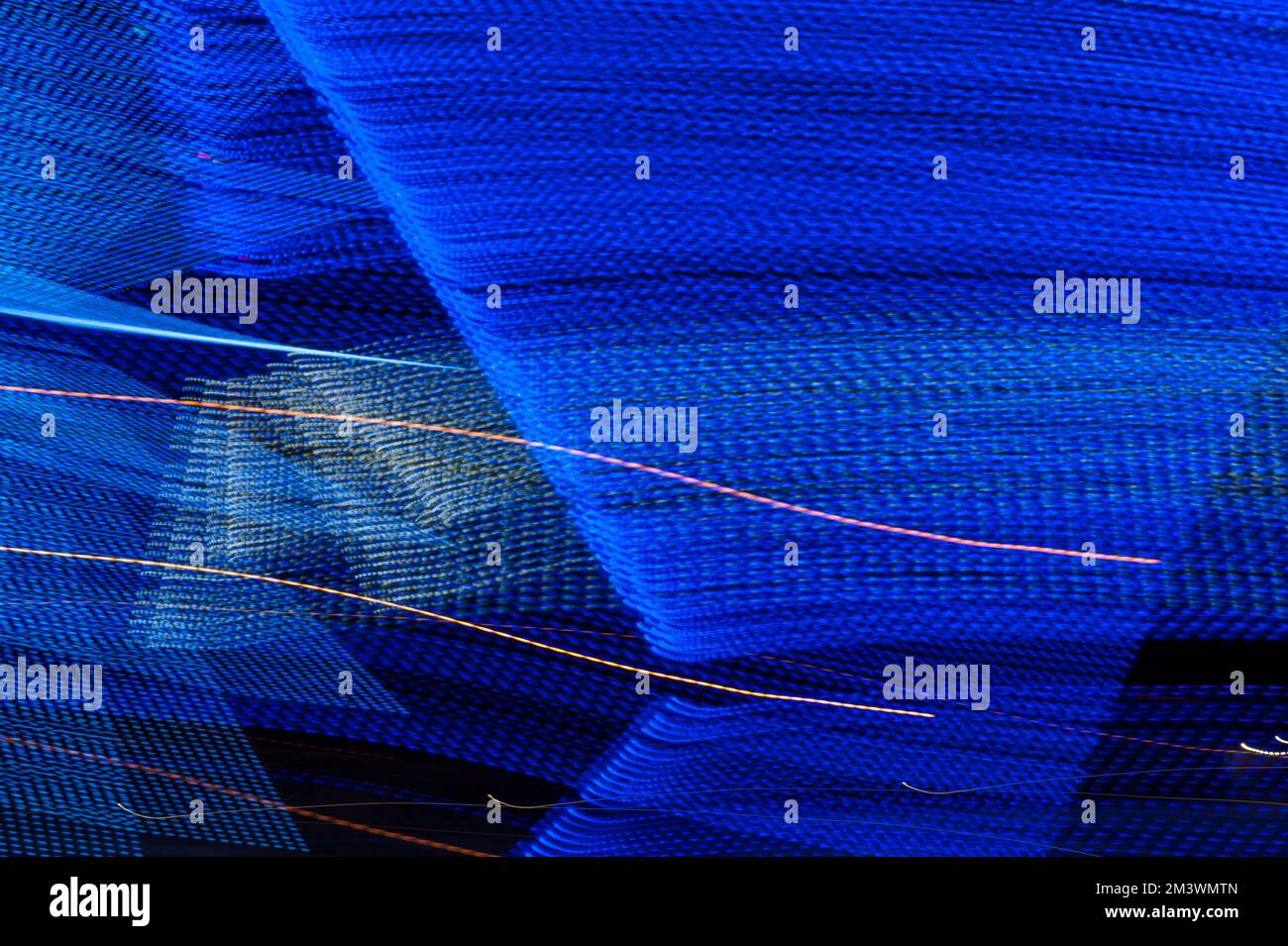 Motion effect, light trails. Rotating illuminated attraction in ...