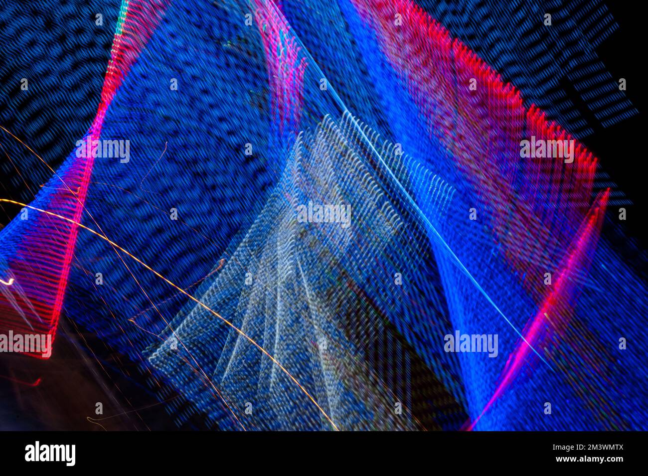 Motion effect, light trails. Rotating illuminated attraction in ...