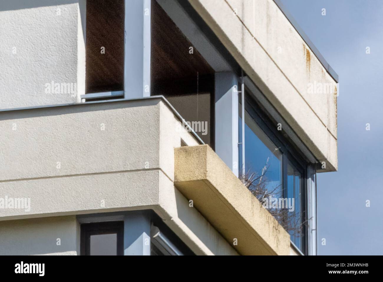 A low angle of the big windows and facade of a residential building ...